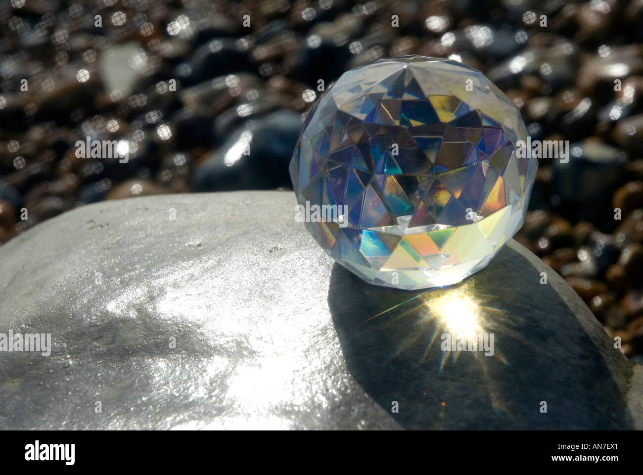 Glass ball crystal ball on pebble beach Stock Photo - Alamy