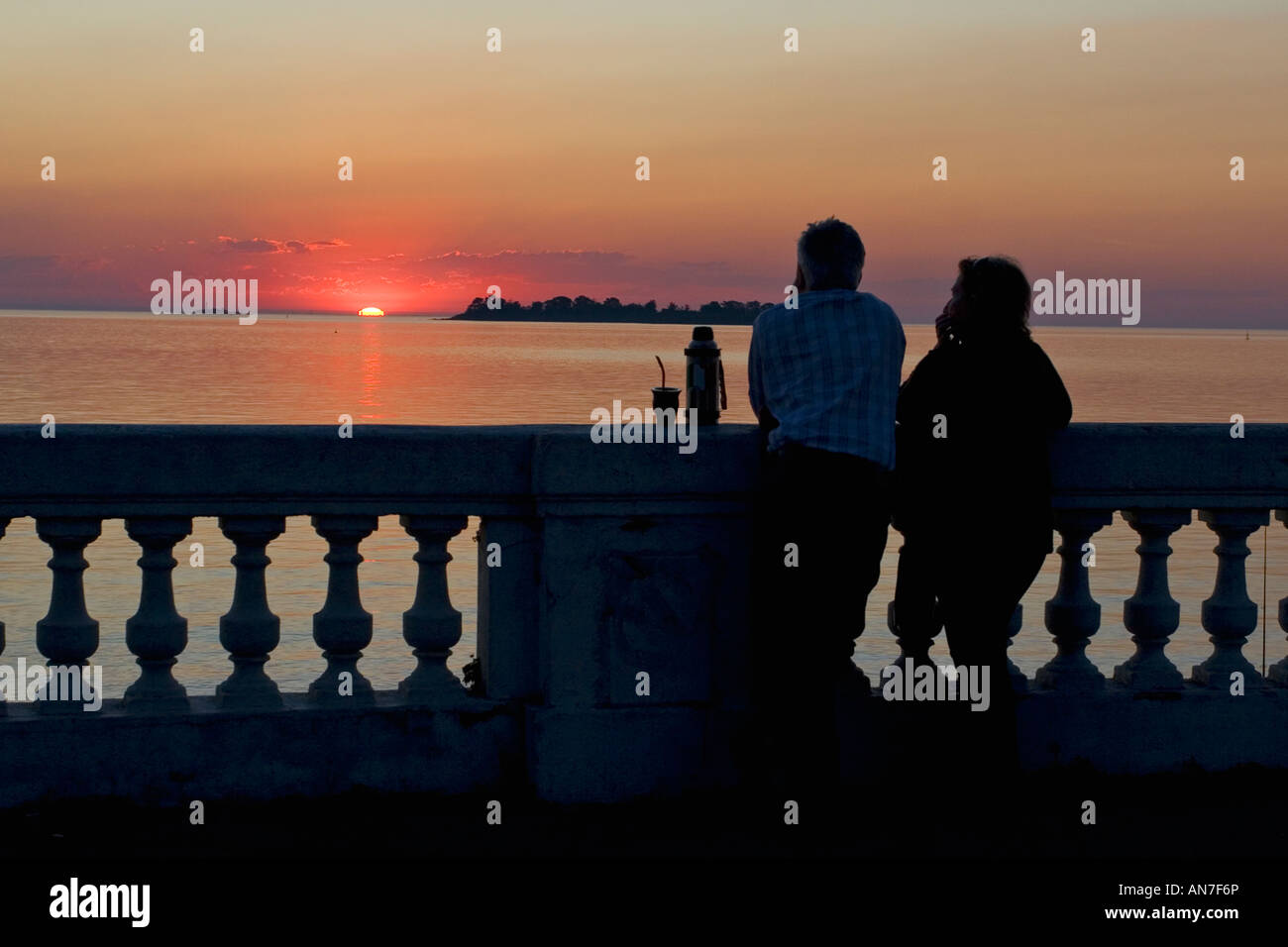 Silhouette of Couple at Sunset with Mate Stock Photo - Alamy