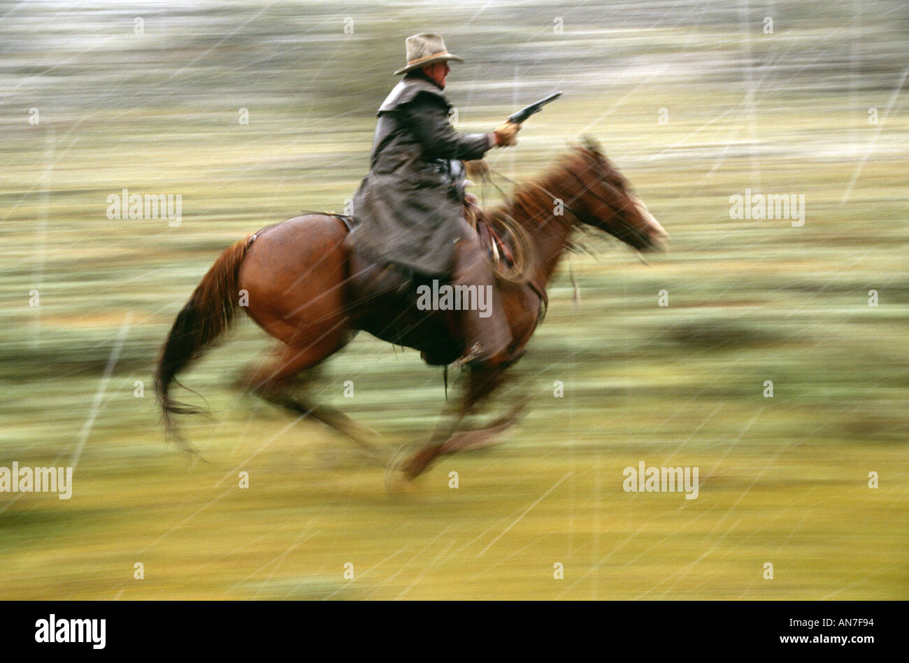 Cowboy with gun riding through snow storm Wyoming USA Stock Photo - Alamy