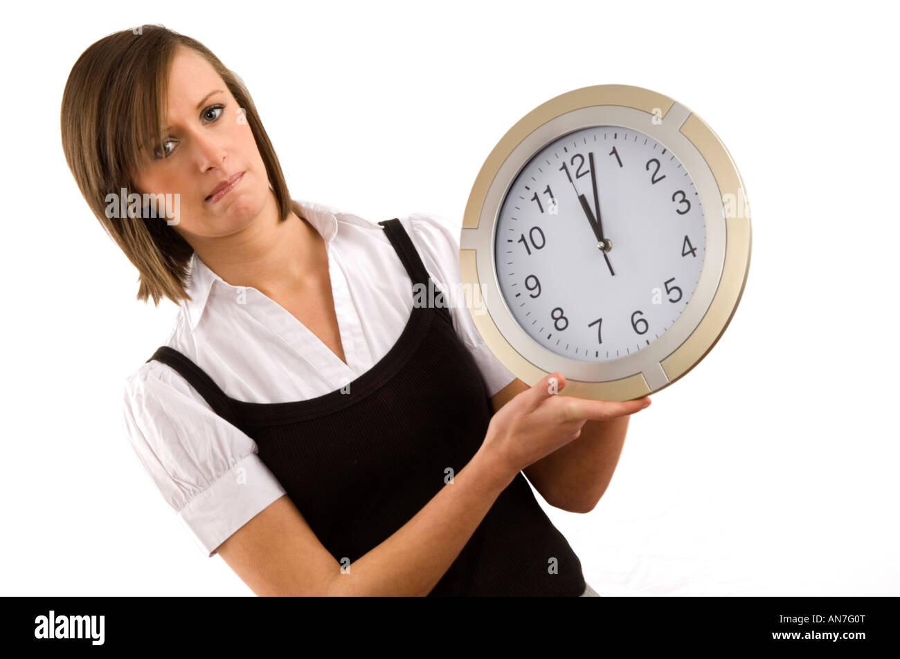 woman with a clock looking worried Stock Photo - Alamy