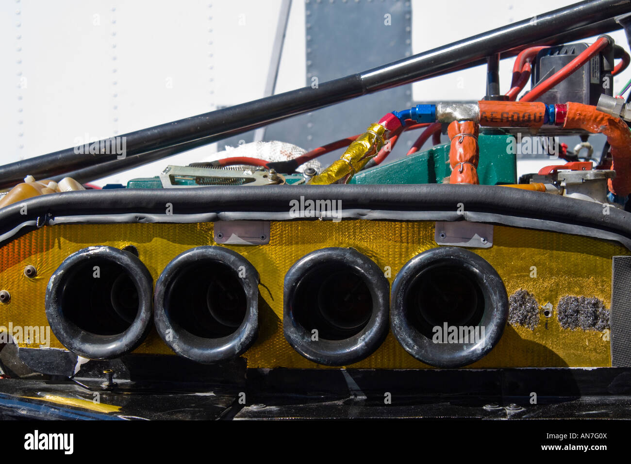 Sideview of four engine exhaust ports on open racecar Stock Photo - Alamy