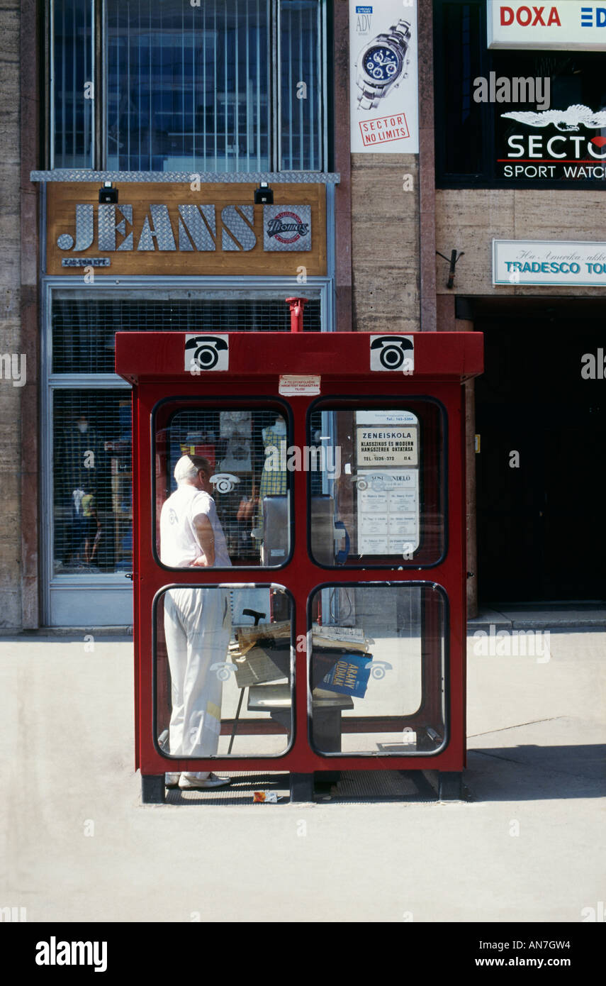A caller inside one of a pair of telephone boxes both displaying a logo ...