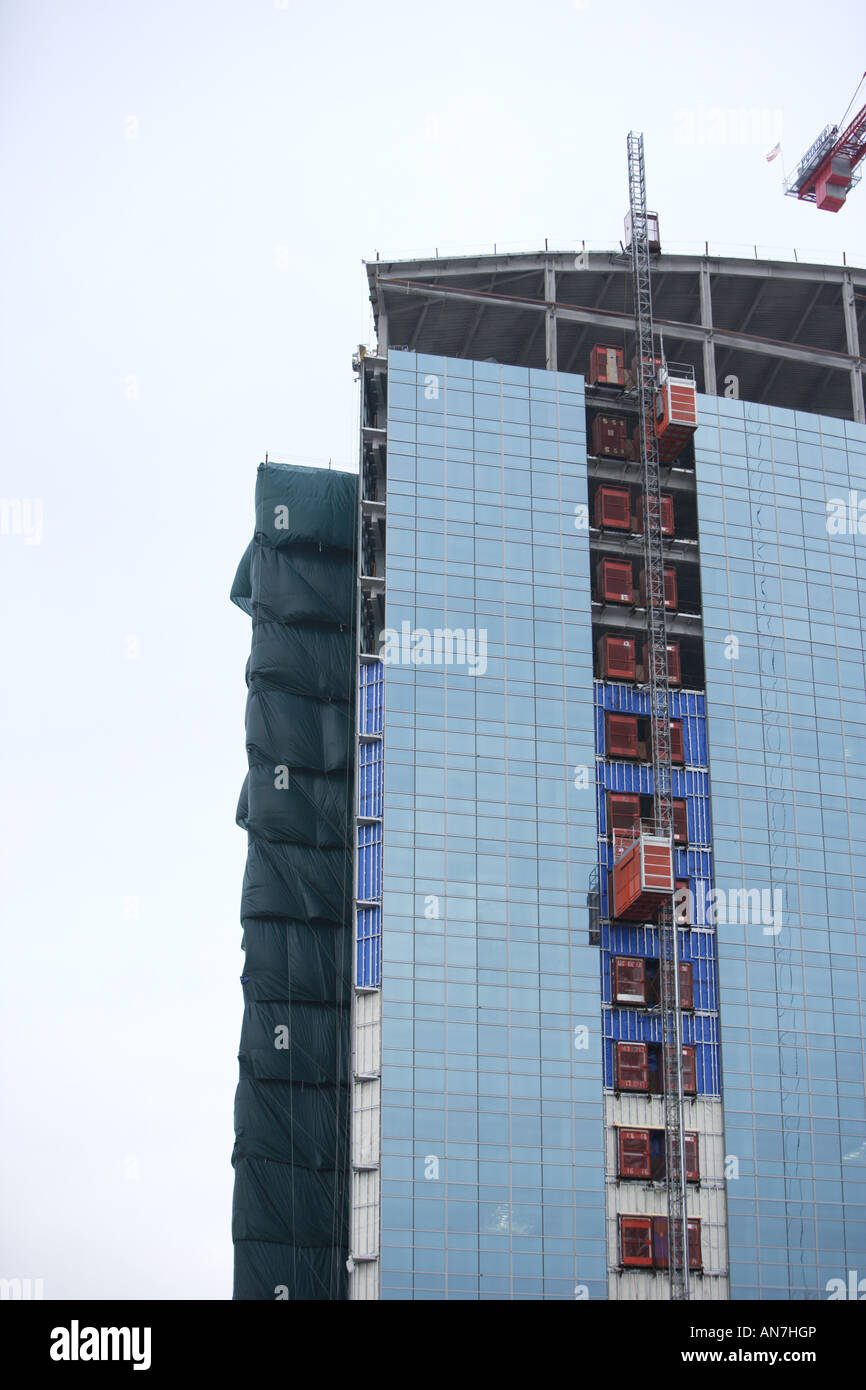 Construction elevators climb the side of a new high rise Stock Photo ...