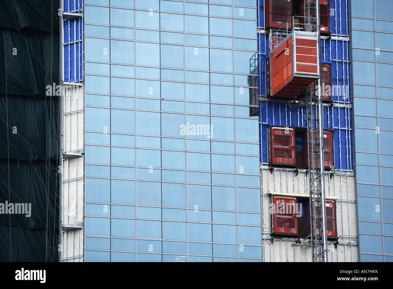 Construction elevators climb the side of a new high rise Stock Photo ...