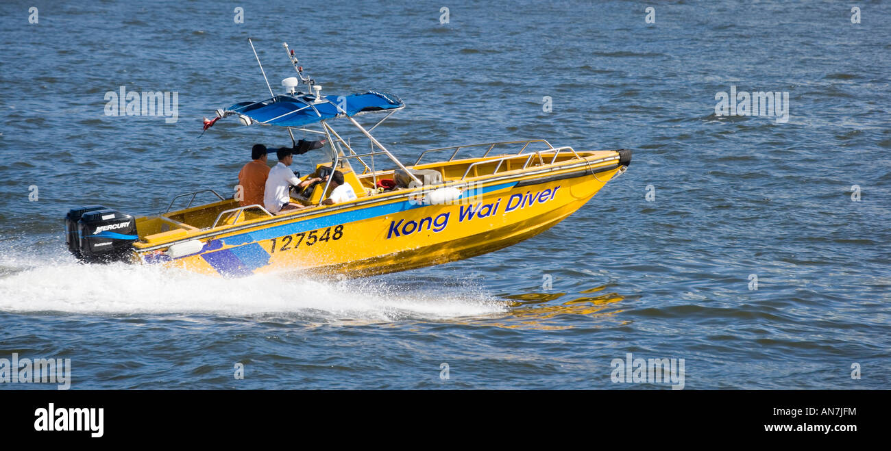 Yellow speed boat Hong Kong Stock Photo - Alamy