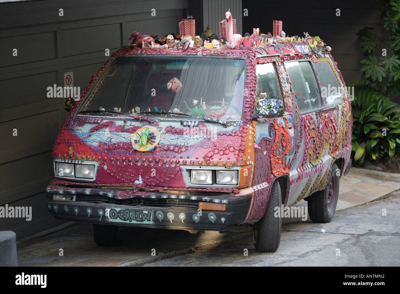 Van with various items stuck on and painted Stock Photo - Alamy