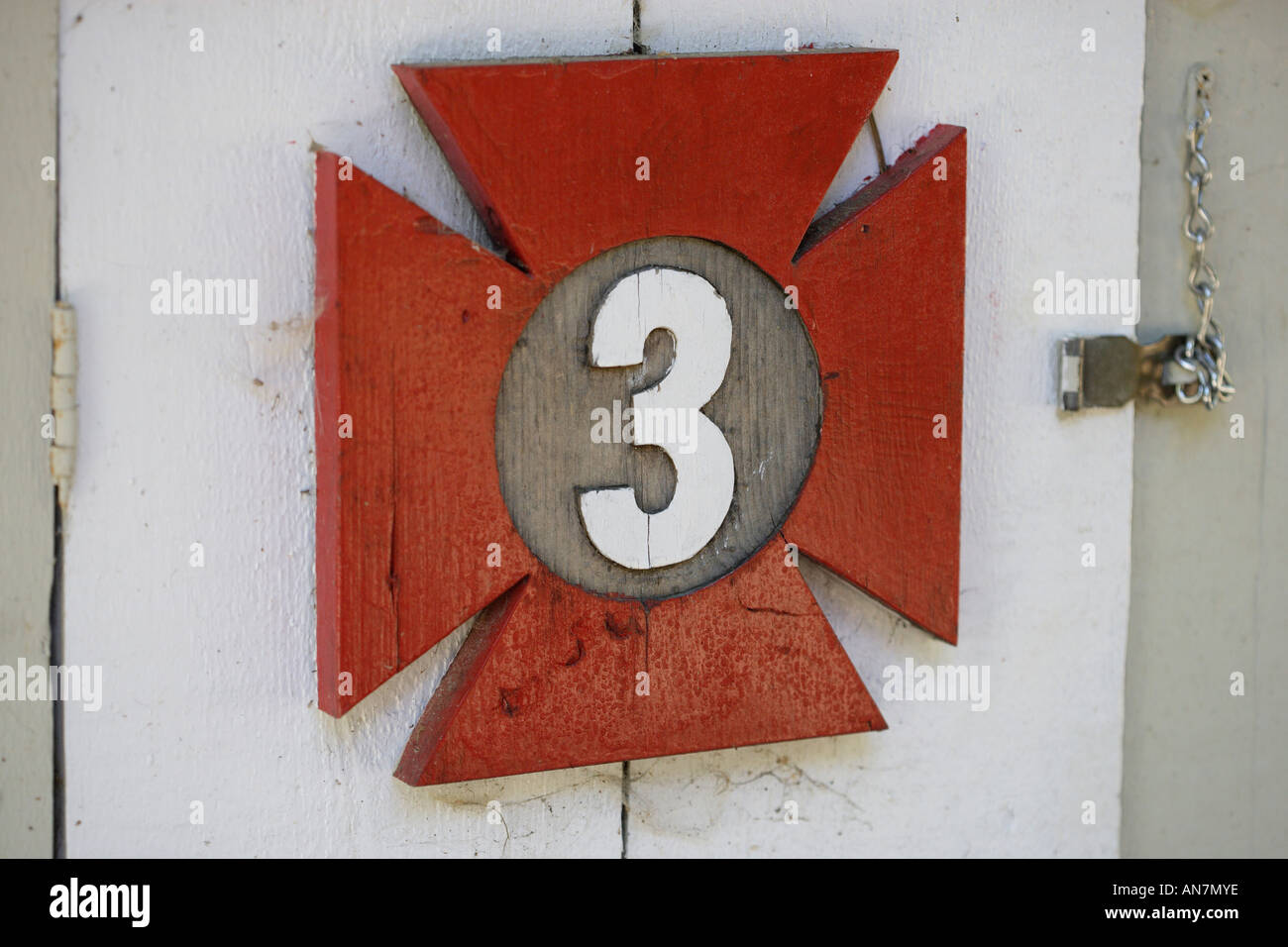 Three the number painted on a plaque Stock Photo - Alamy