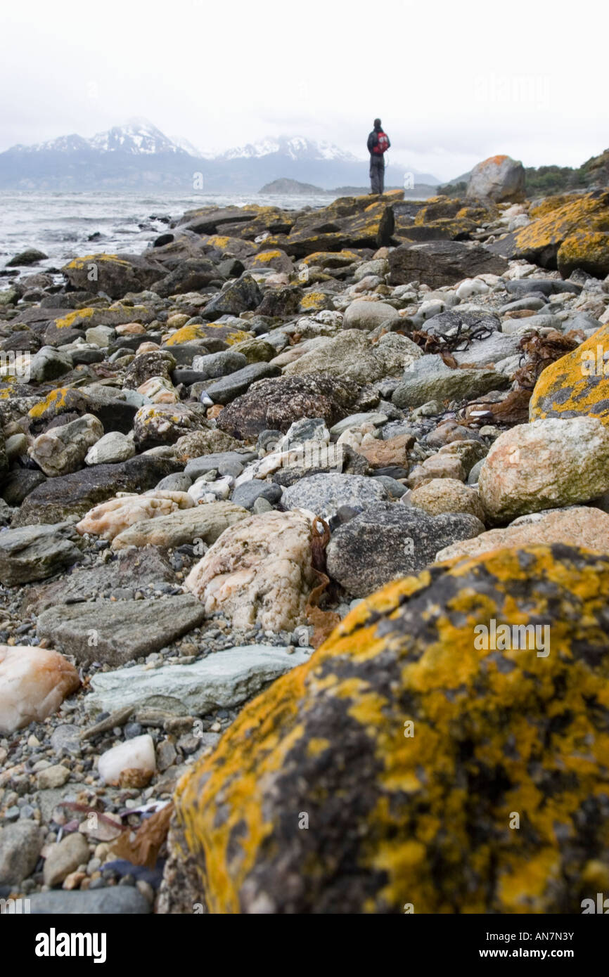 Distant Figure stood on Rocky Beach Stock Photo - Alamy