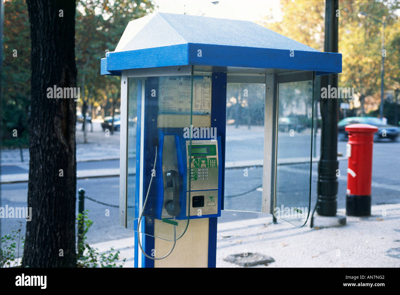 Detail of a modern public telephone beneath its distictive blue canopy ...