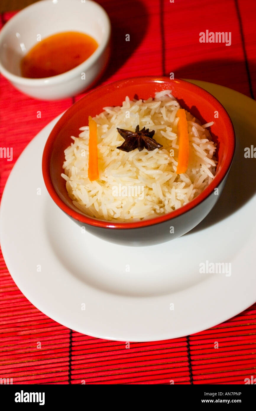 Chinese rice meal bowl on a red bamboo matting pace setting with ...