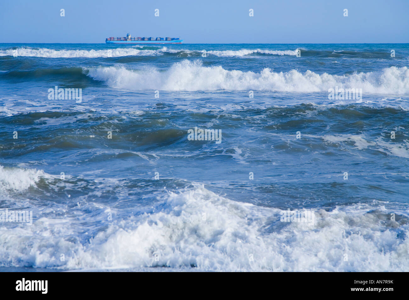 Container ship on horizon of rough sea Stock Photo - Alamy