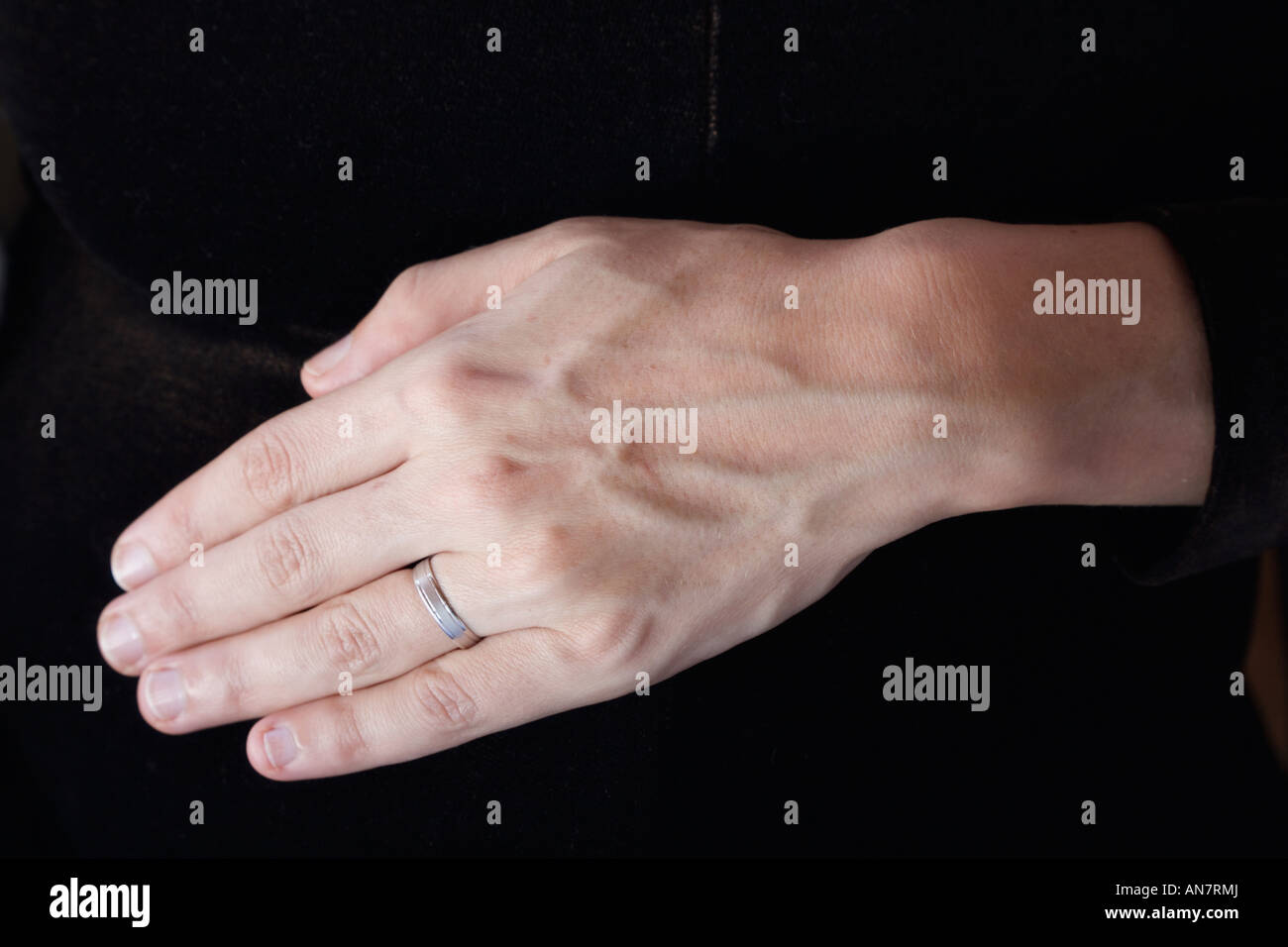 Hand of pregnant woman resting on her stomach Stock Photo - Alamy