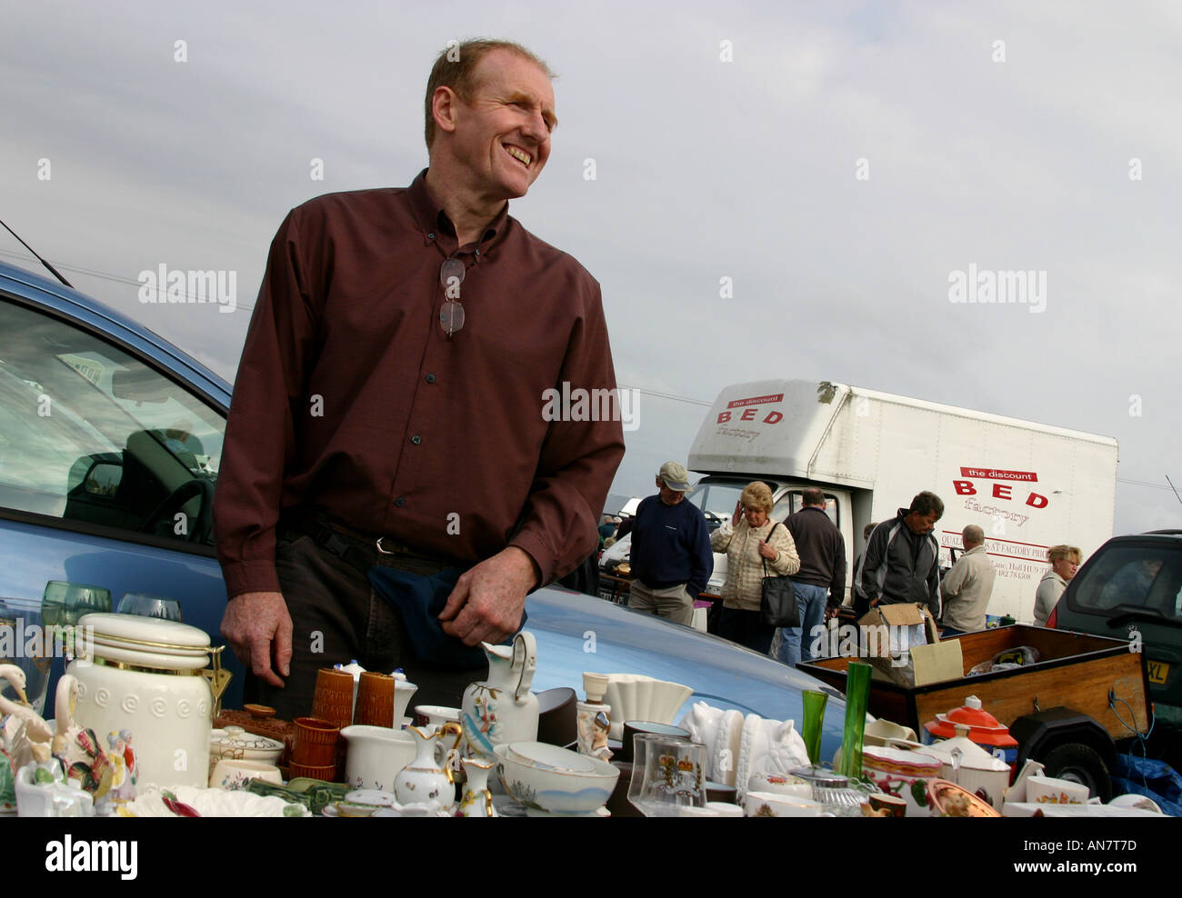 Happy stall holder at car boot sale Stock Photo - Alamy