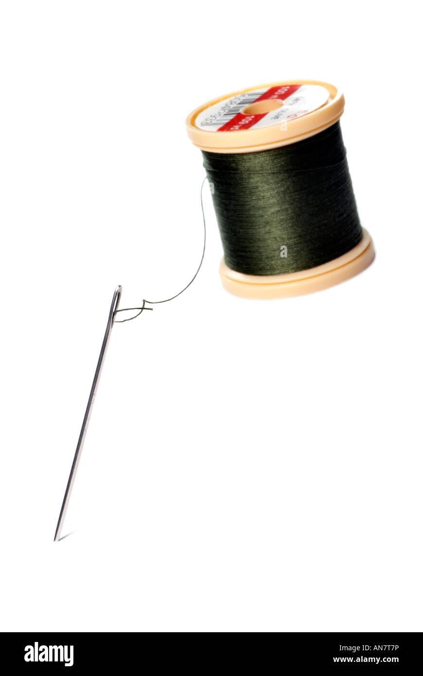 Green cotton bobbin thread and needle Stock Photo - Alamy