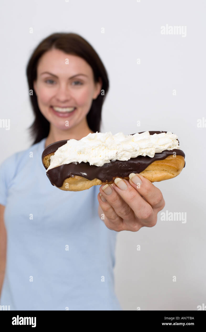woman tempting someone with a chocolate and cream slice Stock Photo - Alamy