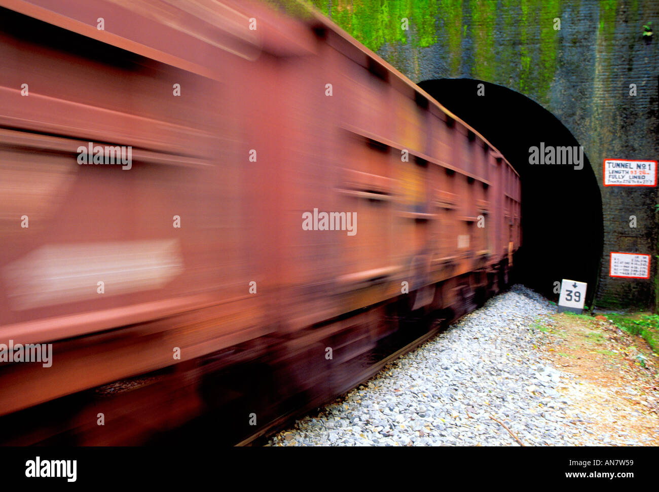 Railway Goods Vans Cargo train in motion entering a tunnel freight ...