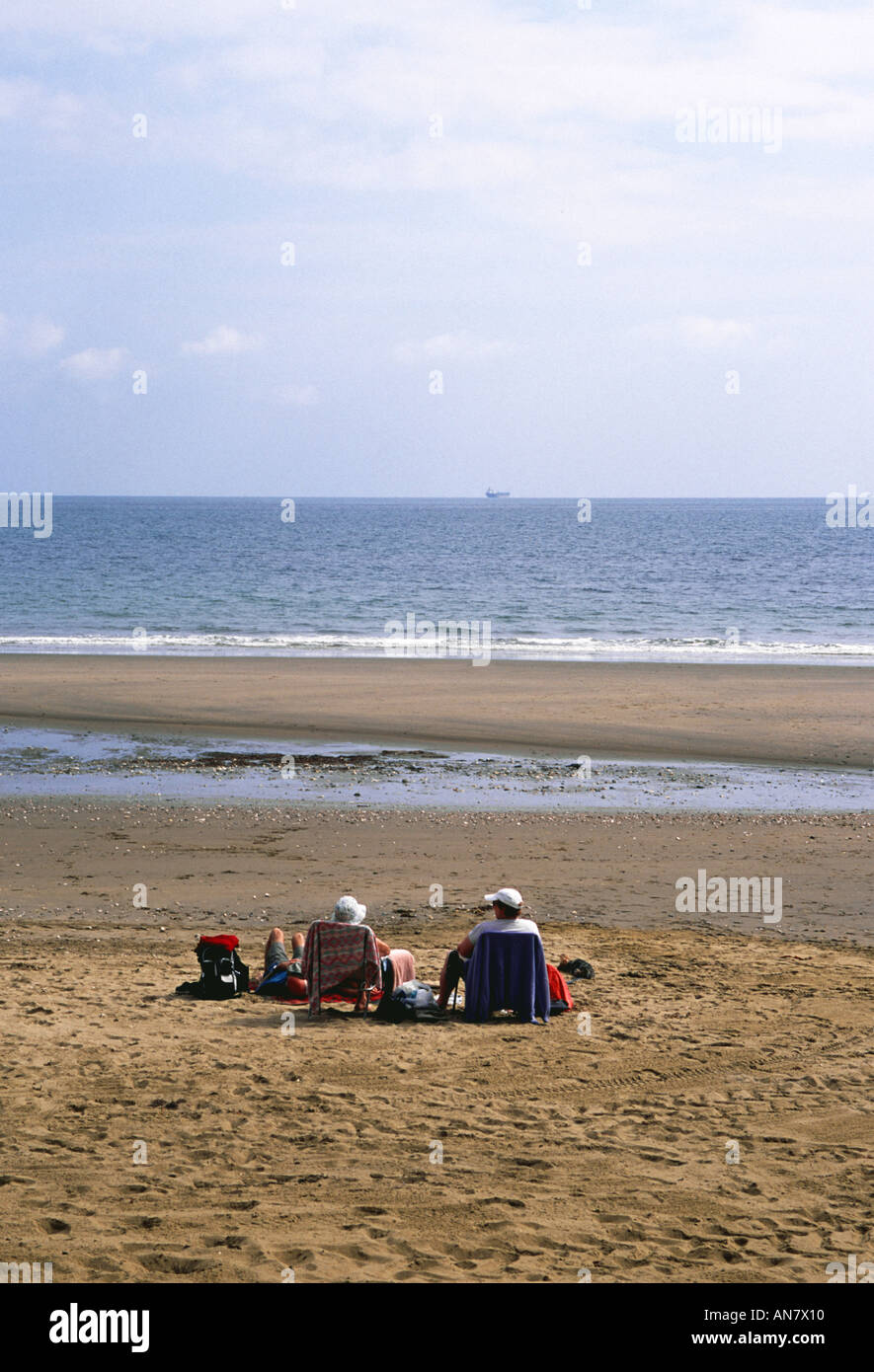 PEOPLE ON DESERTED BEACH Stock Photo - Alamy