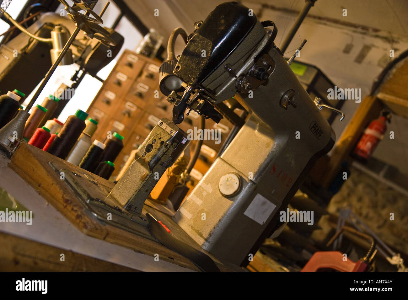 Old sewing machine as used by traditional shoe makers In the background ...