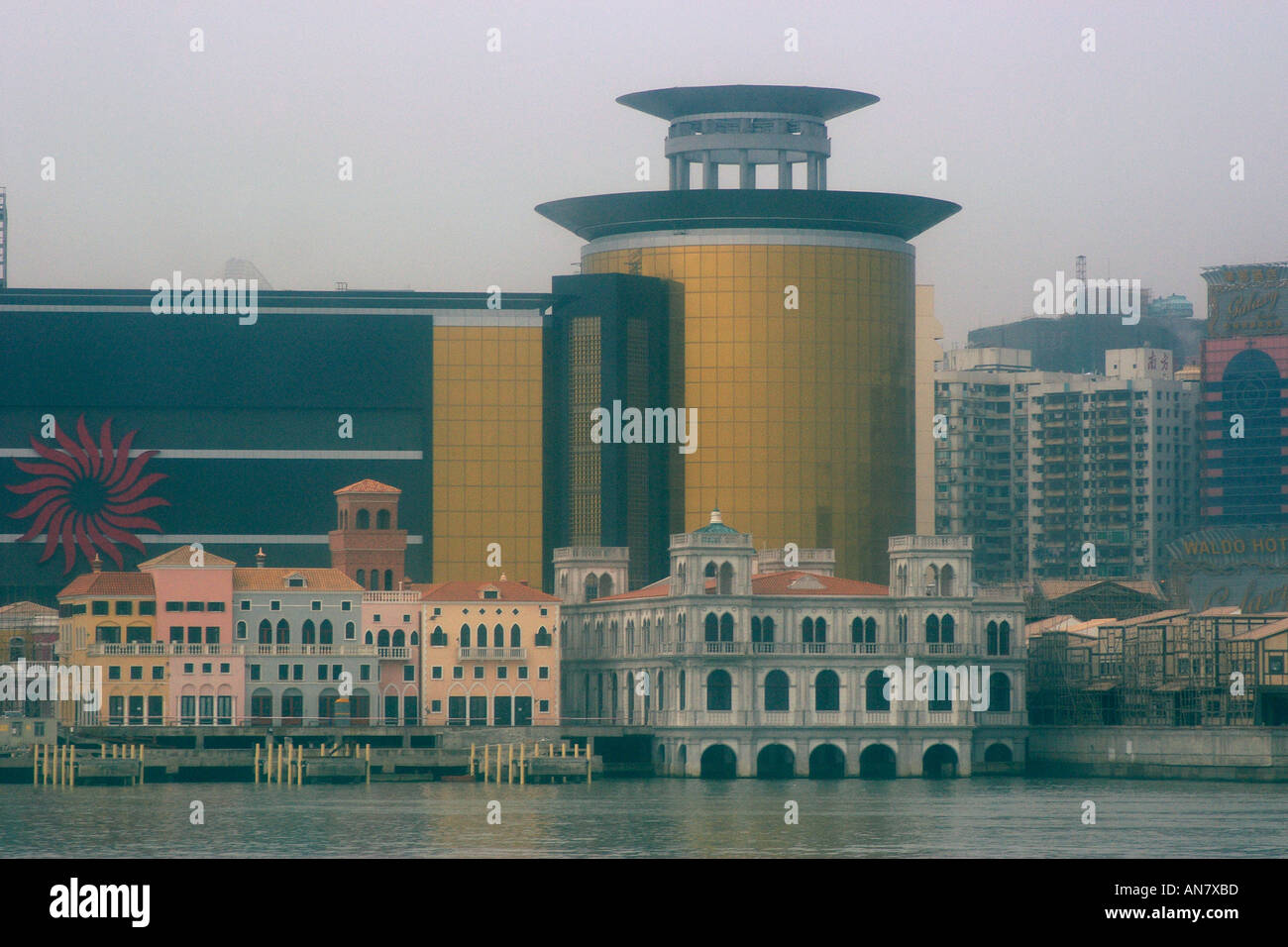 Old colonial water front buildings contrast with a modern casino built ...