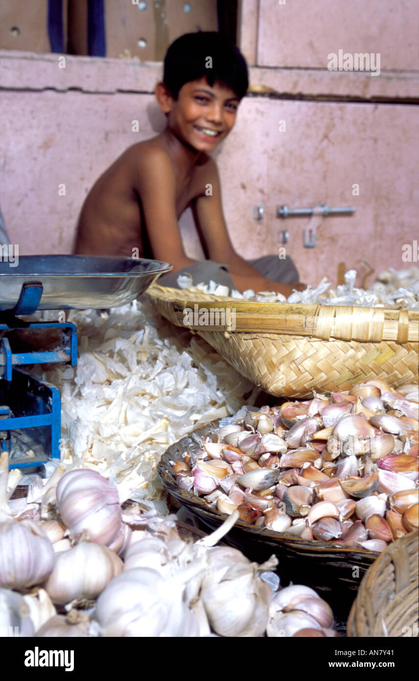 Baskets with garlic and a little vendor boy pulling a charming smile ...