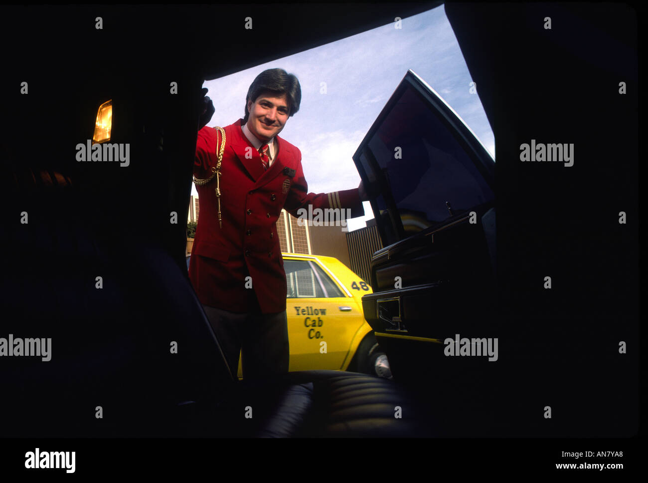 A bell captain greets a guest at a resort hotel Stock Photo - Alamy