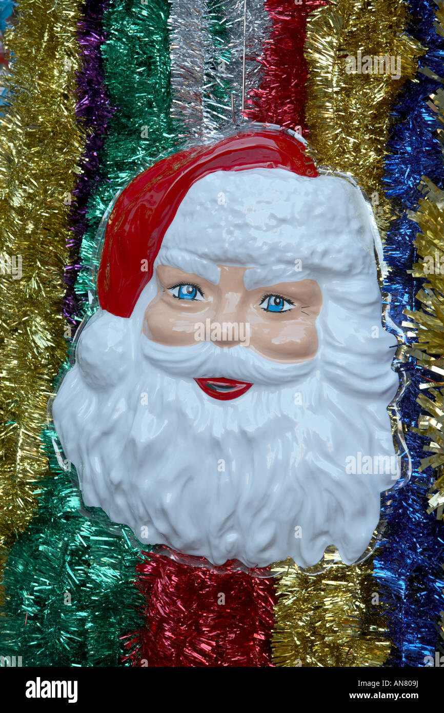 plastic santa face with tinsel on market stall Stock Photo - Alamy