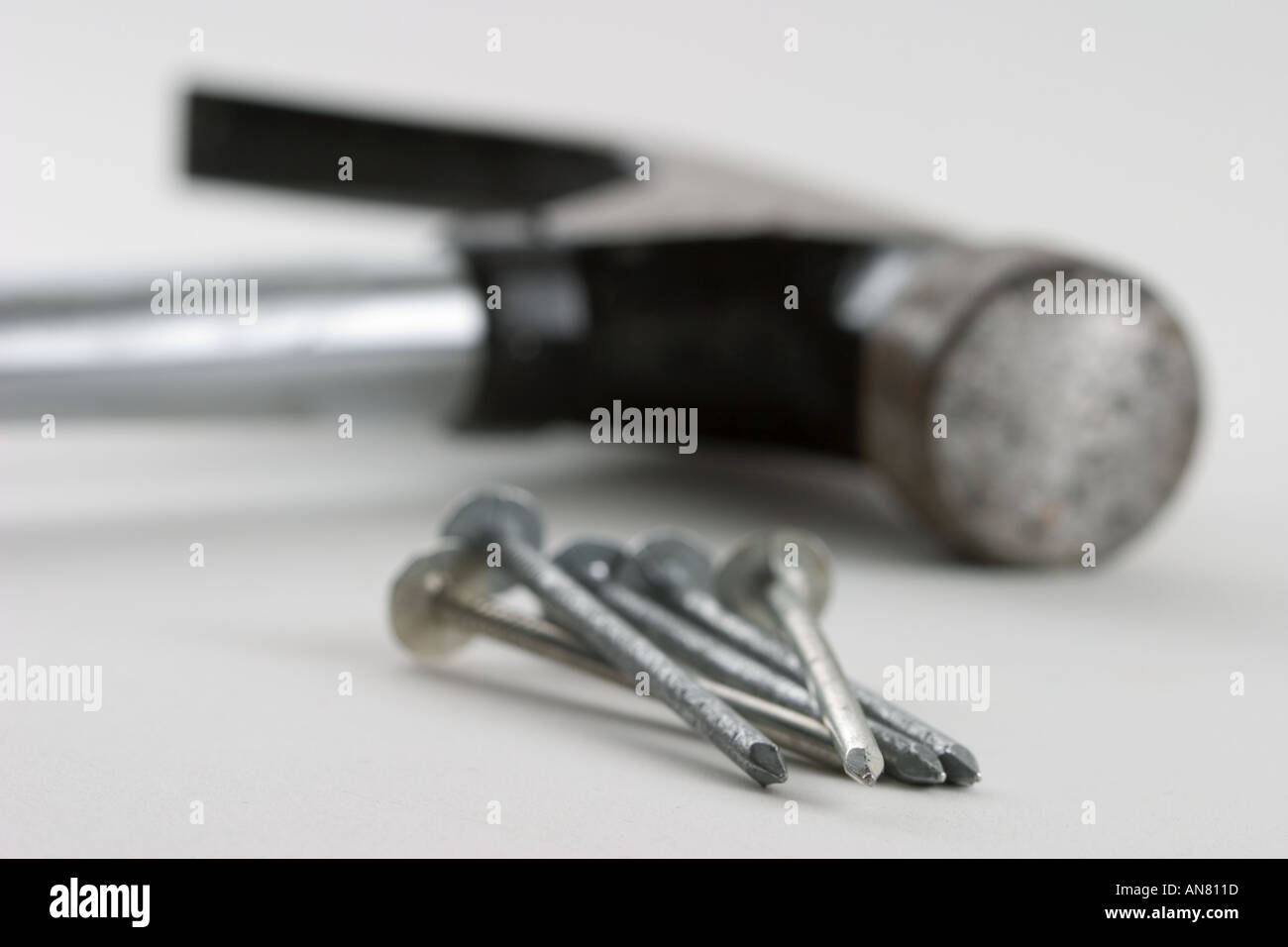 Five nails and hammer Stock Photo - Alamy