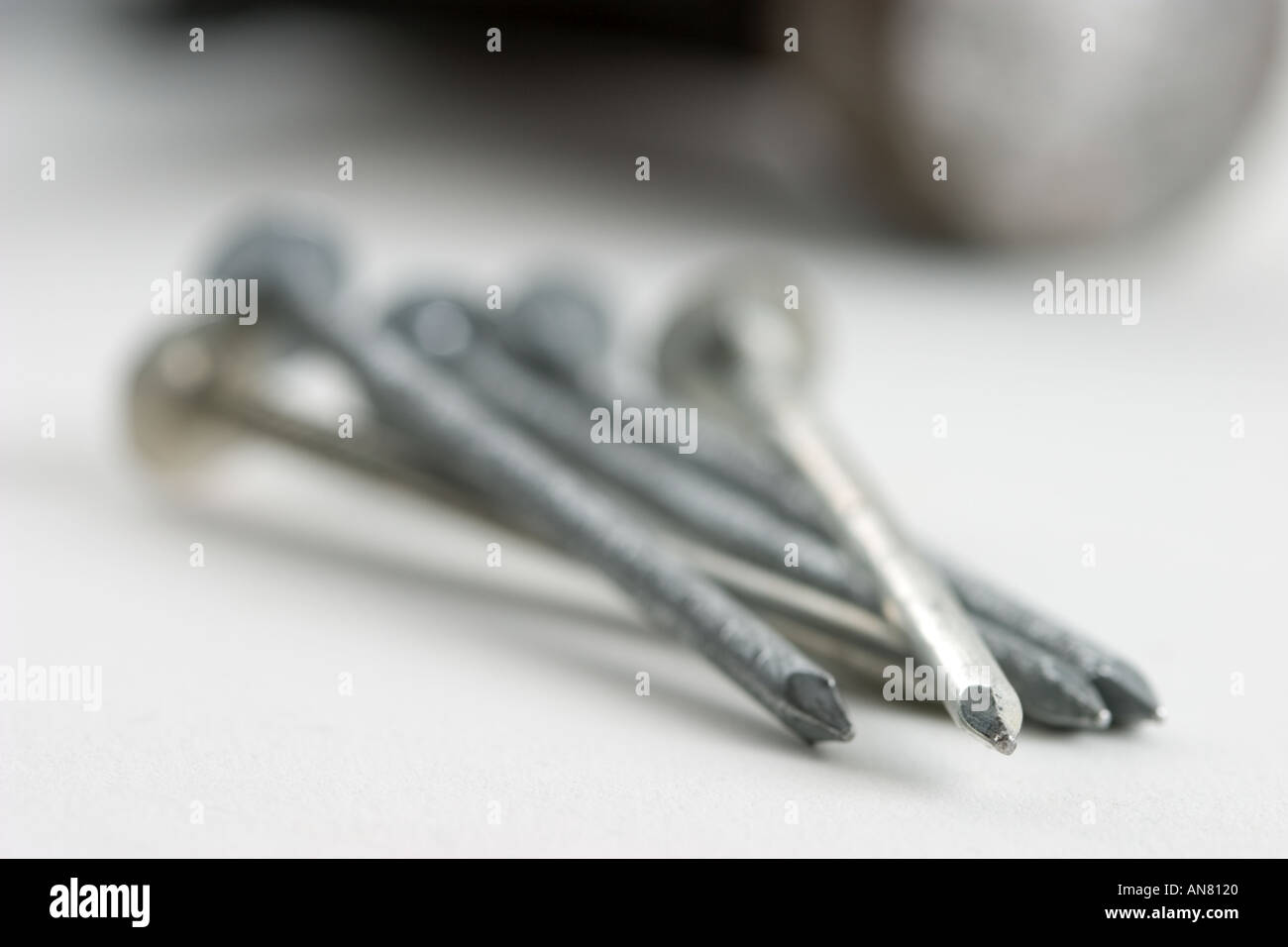 Five nails and hammer Stock Photo - Alamy