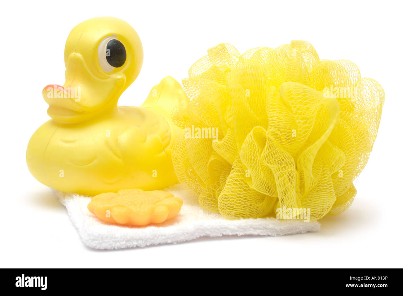 Rubber duck sponge soap and folded towel isolated on a white background ...