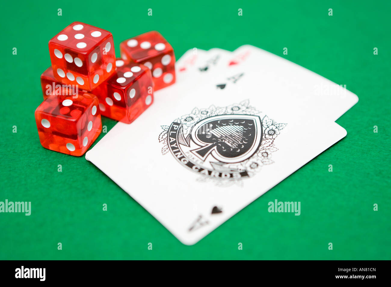 Red dice and aces isolated on green poker table felt Stock Photo - Alamy