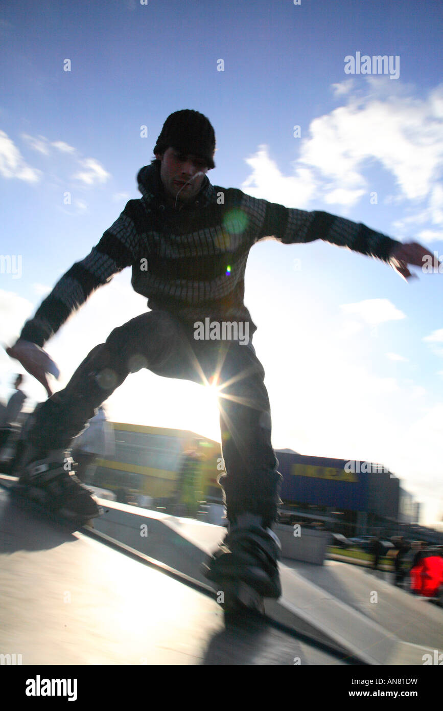 inline skater with inline skates doing tricks at skatepark Stock Photo ...