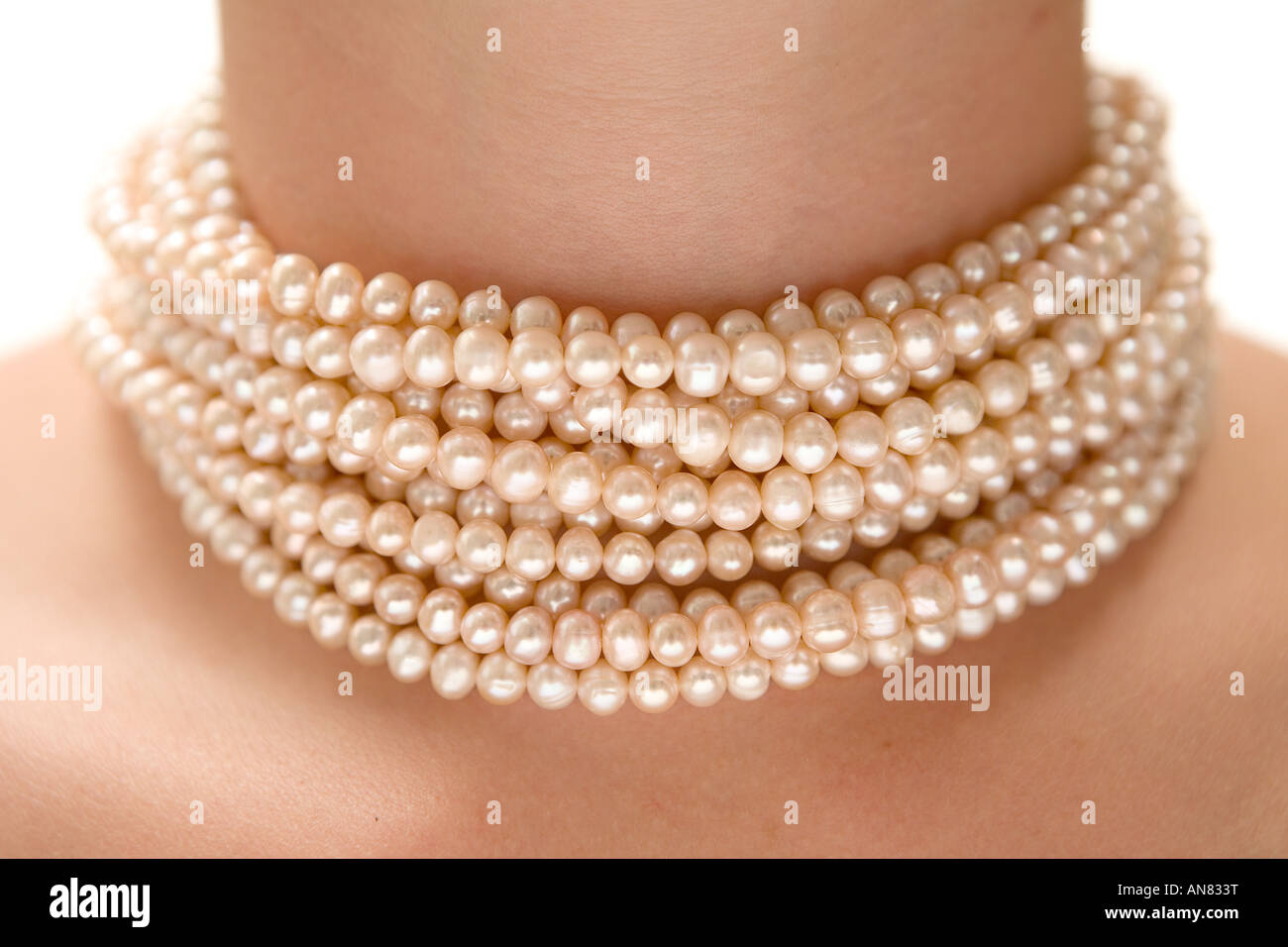 Precious pearls on a womans neck. White background Stock Photo - Alamy