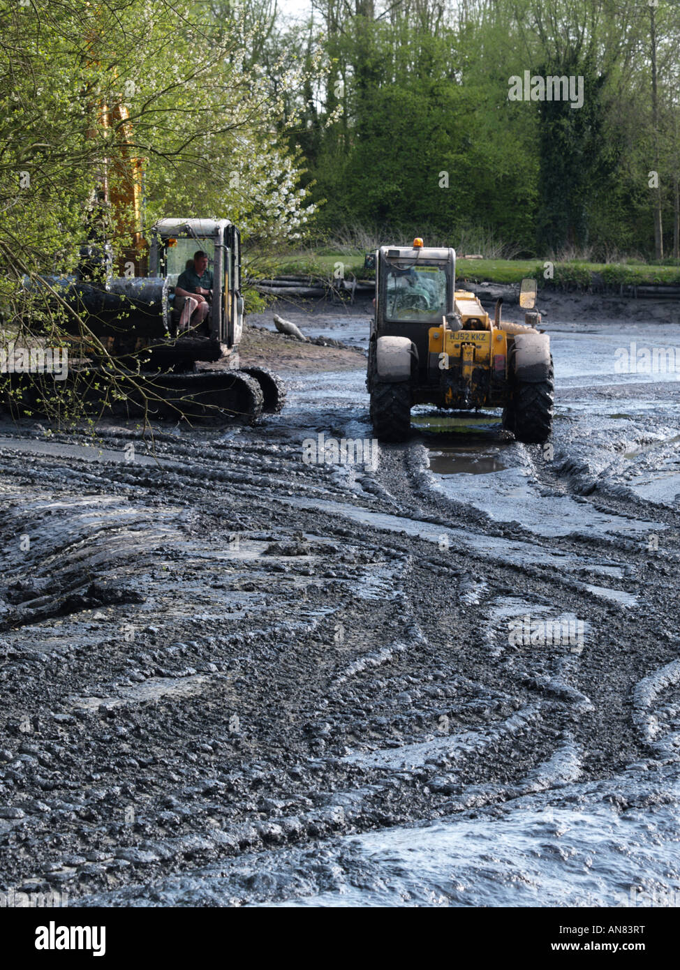 jcb mechanical digger and jcb telehandler in mud Stock Photo - Alamy