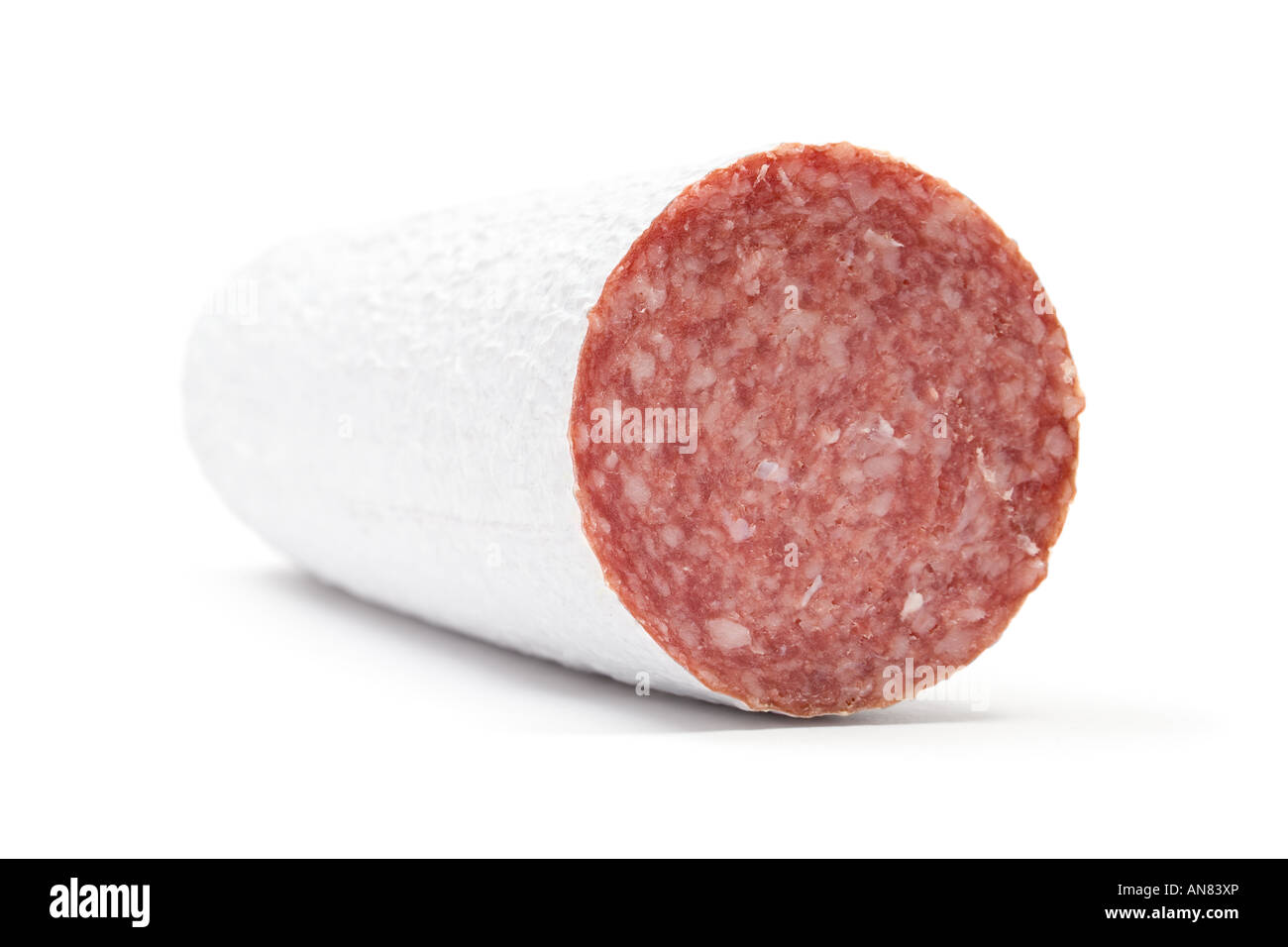 Piece of salami. White background Stock Photo - Alamy