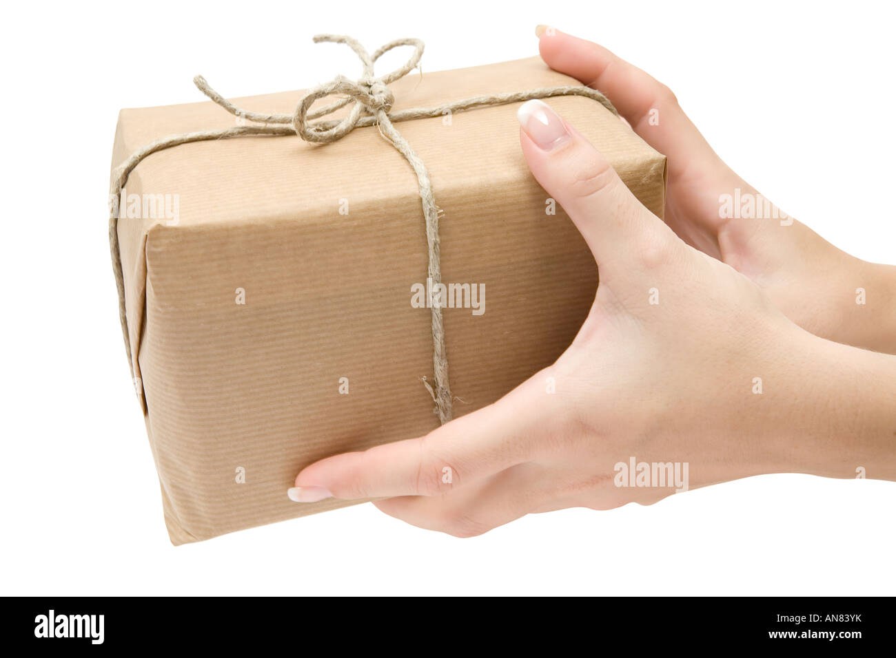 Female hands holding a brown parcel. Isolated on a white background ...