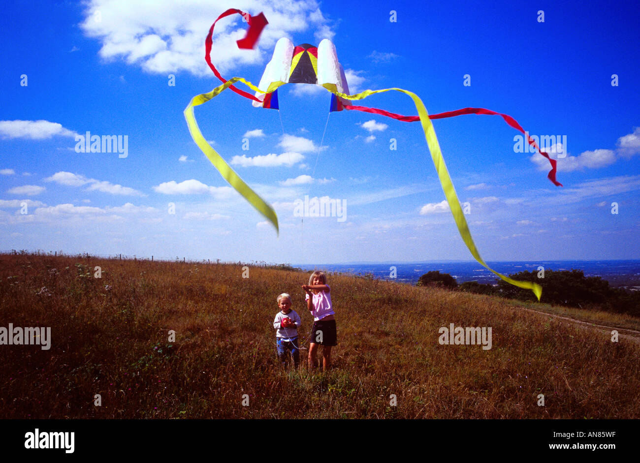 Young children flying a kite on the South Downs England UK Stock Photo ...