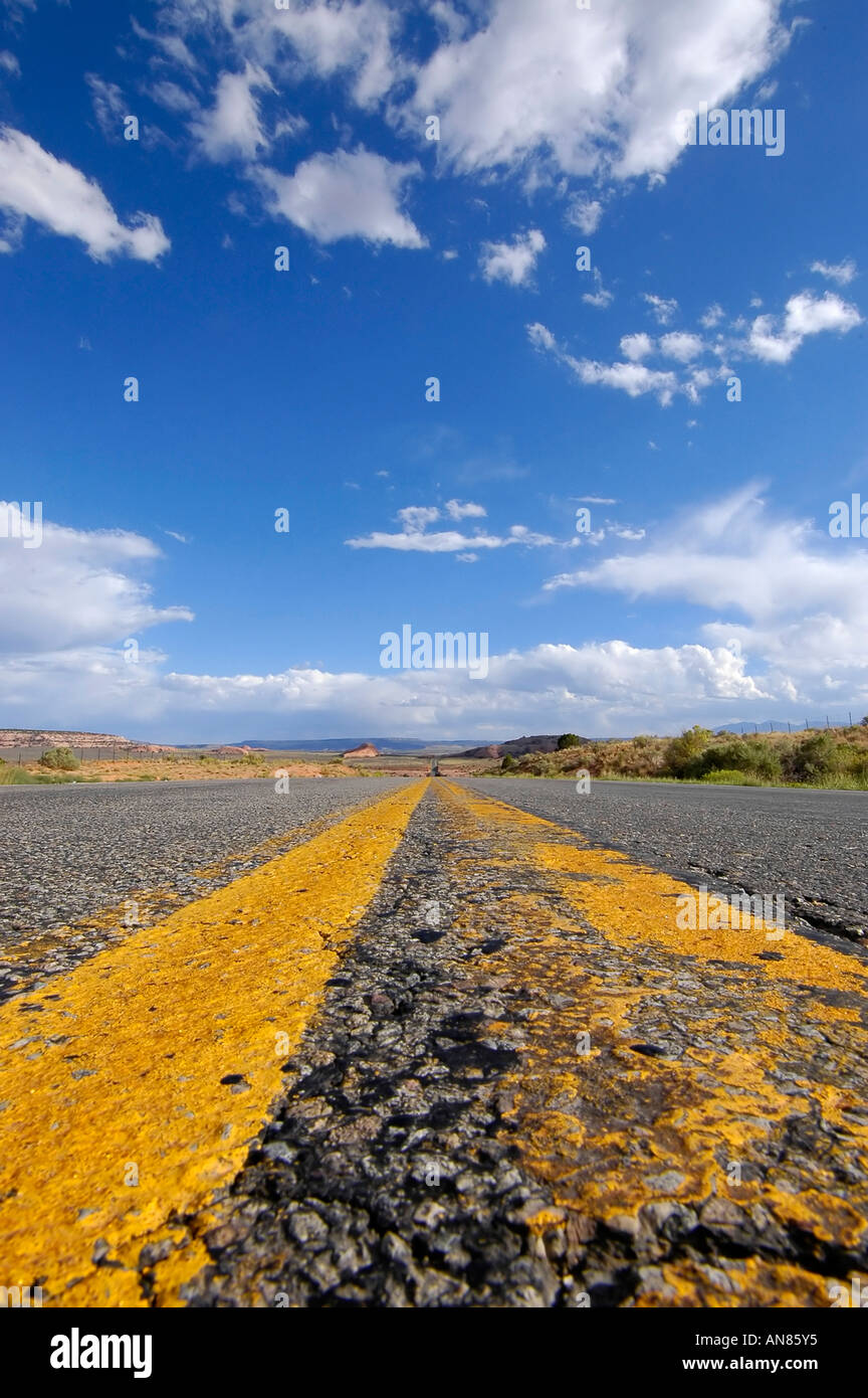 Wide angle shot taken from the yellow divider lines on a highway ...