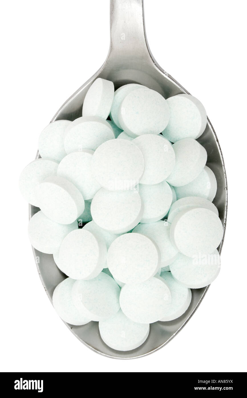 Silver spoon full of tablets. Isolated on a white background Stock ...