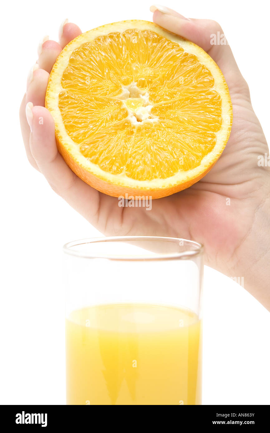 Pressing out an orange. Isolated on a white background Stock Photo - Alamy