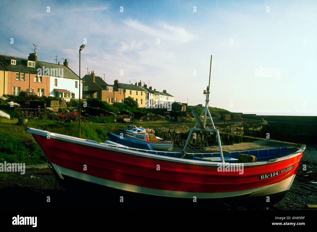 Small craft moored in Craster harbour Stock Photo - Alamy