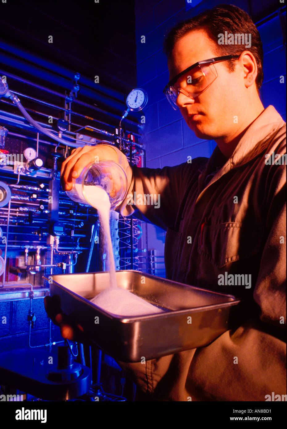 worker pouring plastic granules into container Stock Photo - Alamy