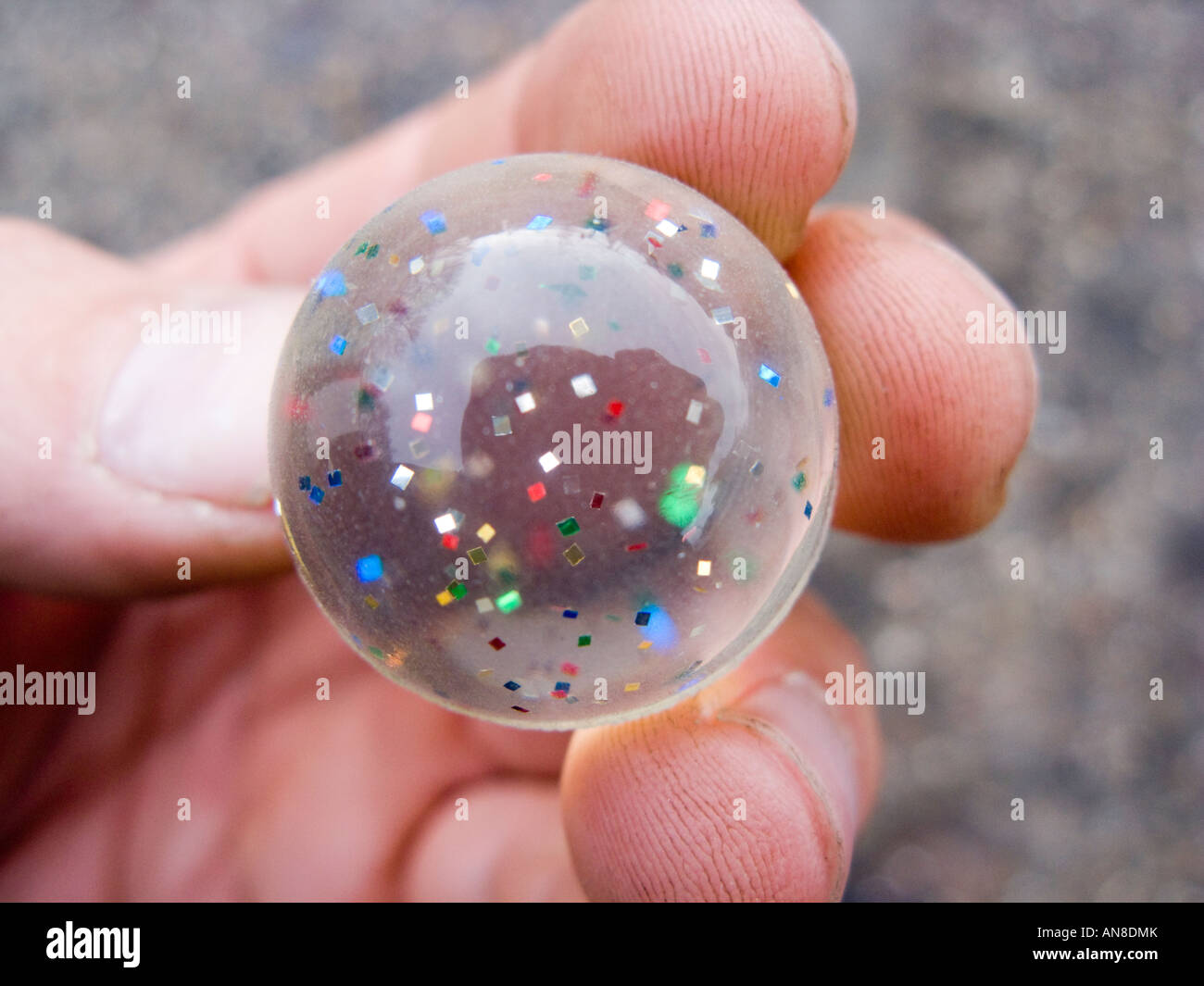male hand holding a bouncy balls Stock Photo - Alamy