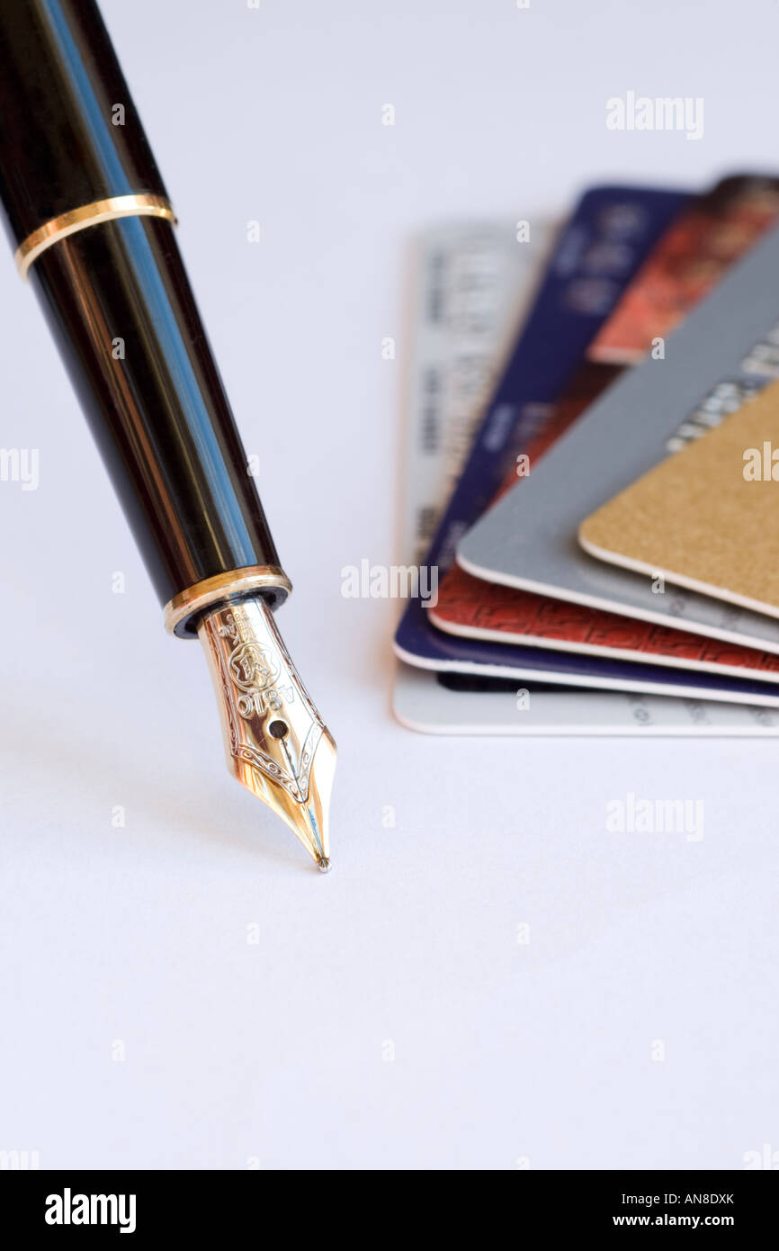 A pen and credit cards on a white background Stock Photo - Alamy