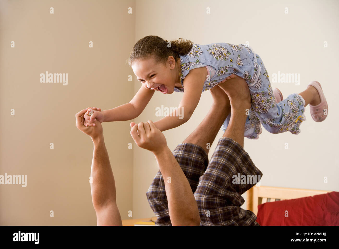 African girl balancing on father’s feet Stock Photo - Alamy