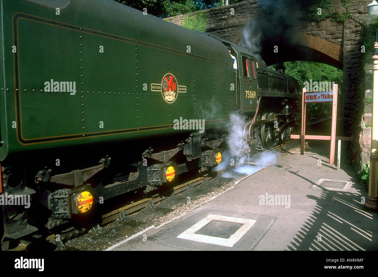 Large green engine leaving the platform of Bishops Lydiard Station West ...