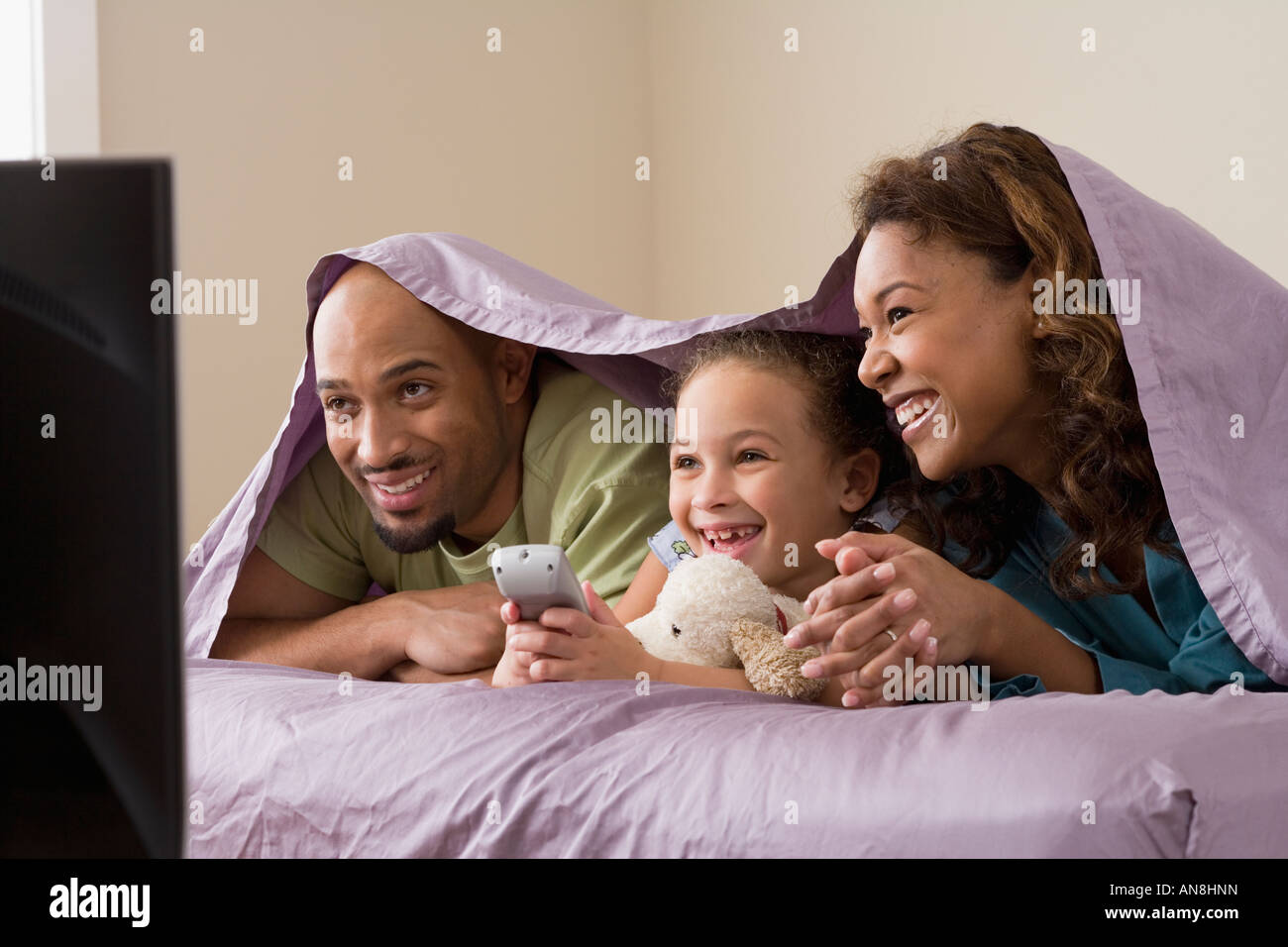 African family watching television Stock Photo - Alamy