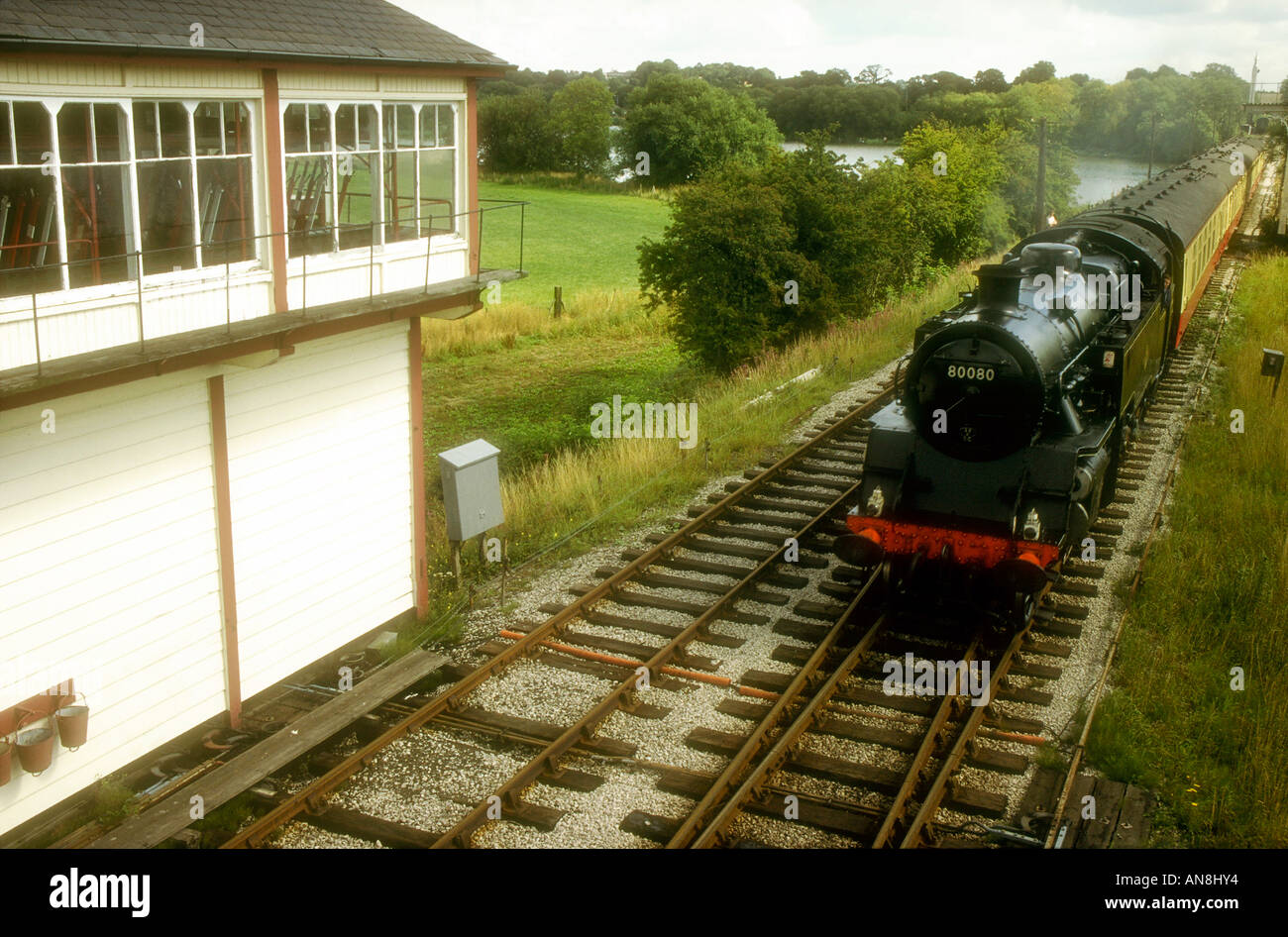 A 1954 steam engine built by British Railways pulling a carriage train ...