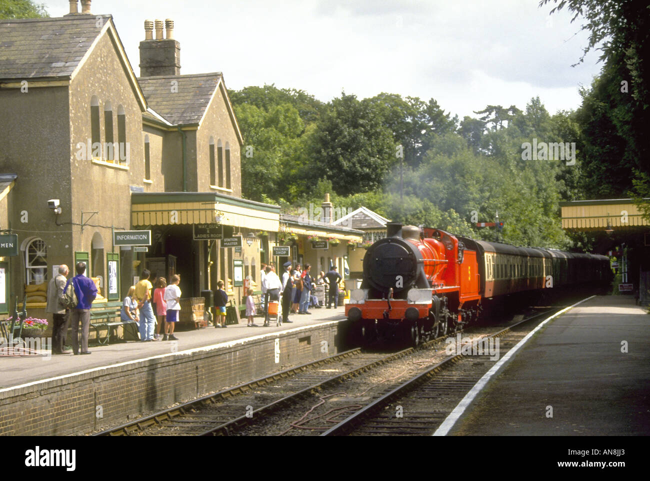 A steam engine stopping at Alresford station on the Watercress Line ...