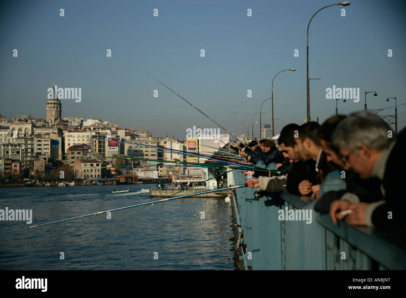 Galata Bridge, Istanbul, Turkey, with the fishers and the Galata Tower ...