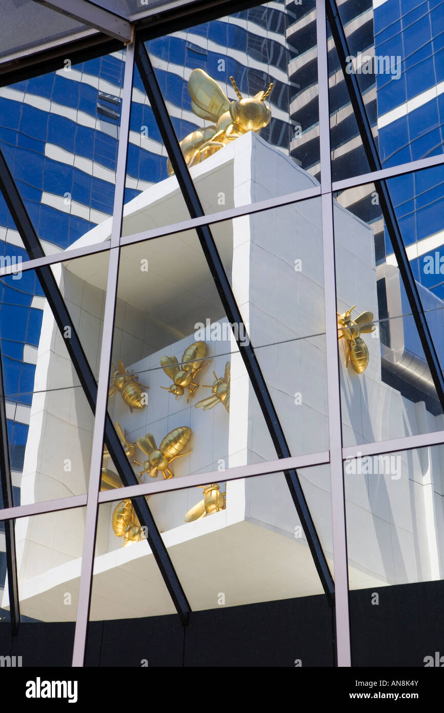 Reflection of art installation featuring gold bees on Eureka Tower ...